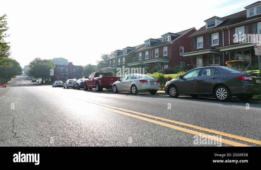 Extremely low gliding shot over small town road. Aerial flight over ...