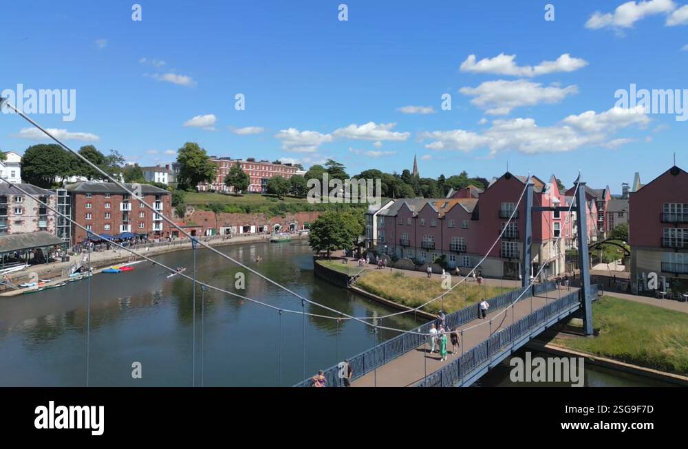 The River Exe Suspension Bridge. People walk across as the drone flys ...