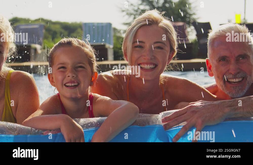 Smiling Multi-Generation Family On Summer Holiday Relaxing In Swimming ...