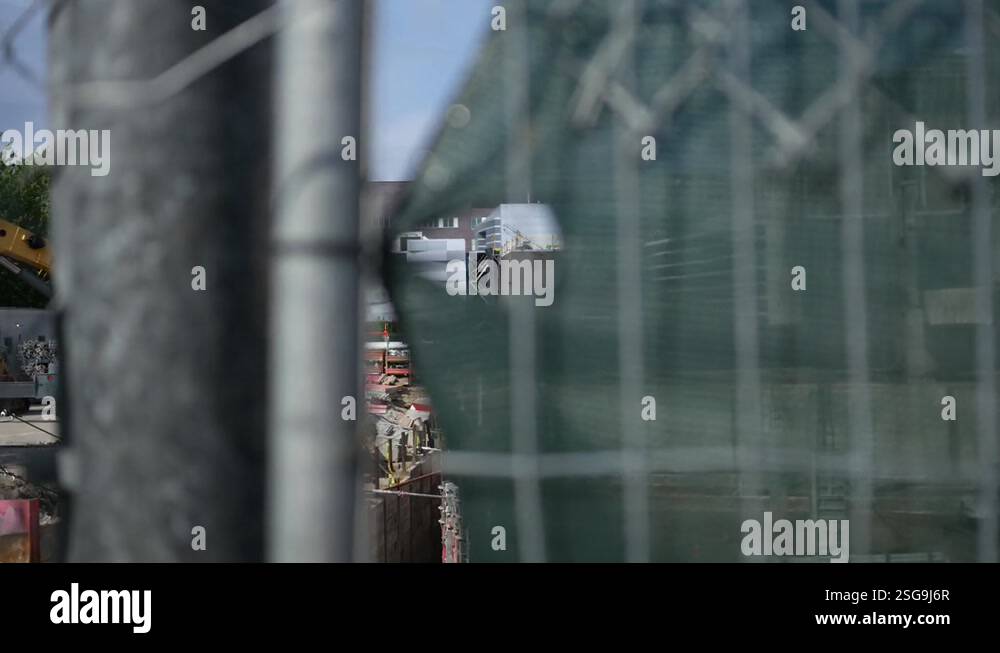 Looking through construction fence at building site Stock Video Footage ...