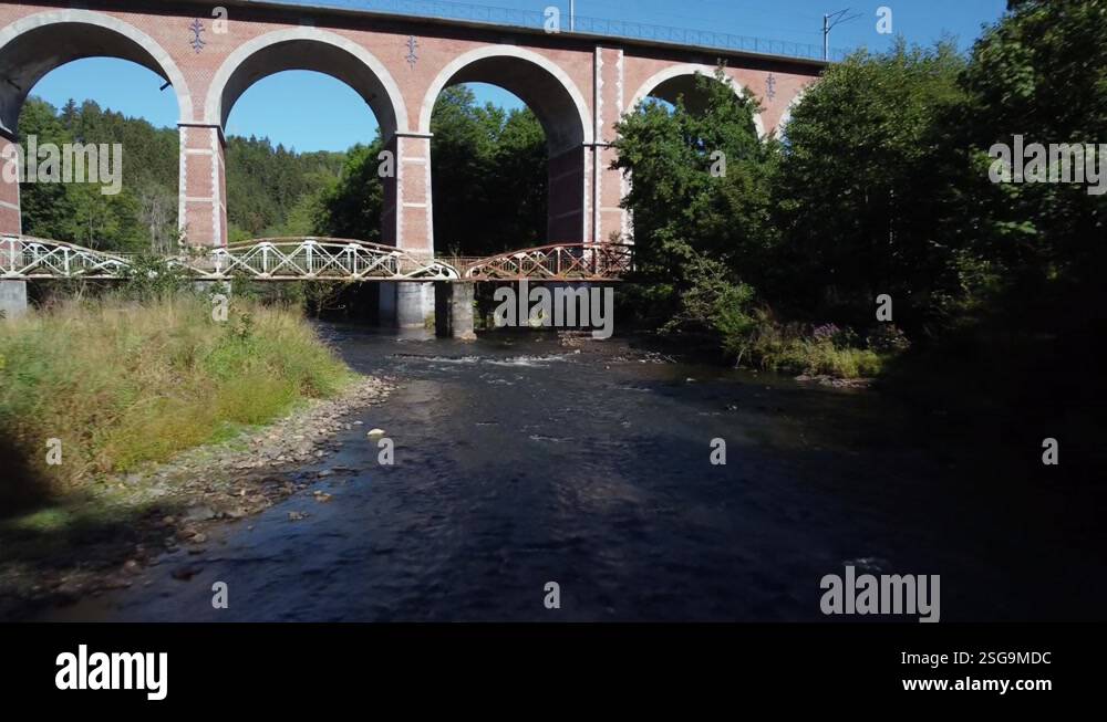 Railroad bridge and old bridge over the Ambleve river, in Roanne-Coo ...
