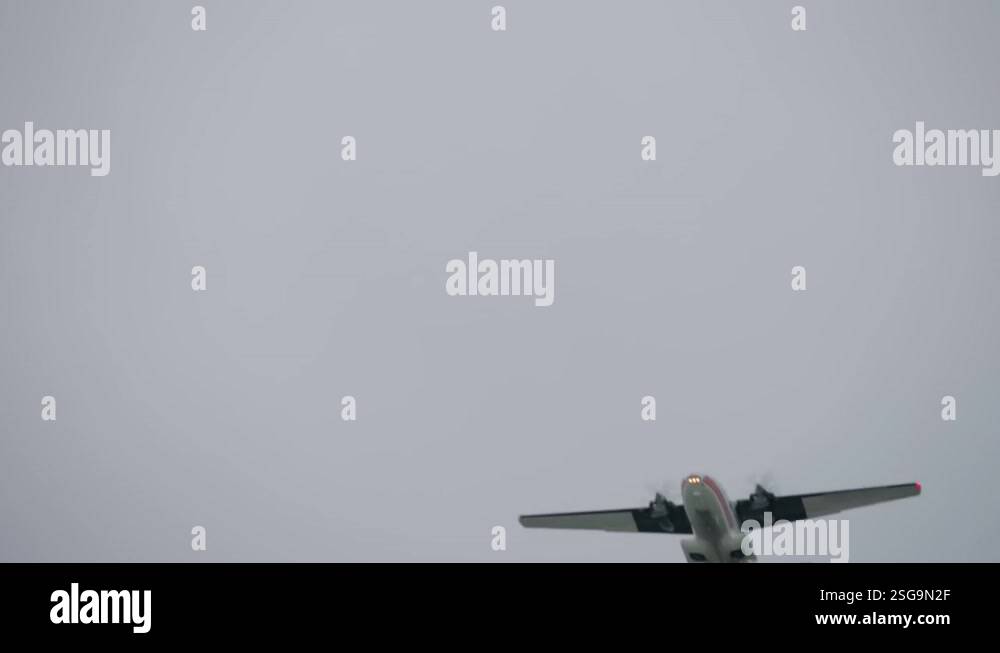Slow motion: light aircraft is gaining altitude and flying in the grey ...
