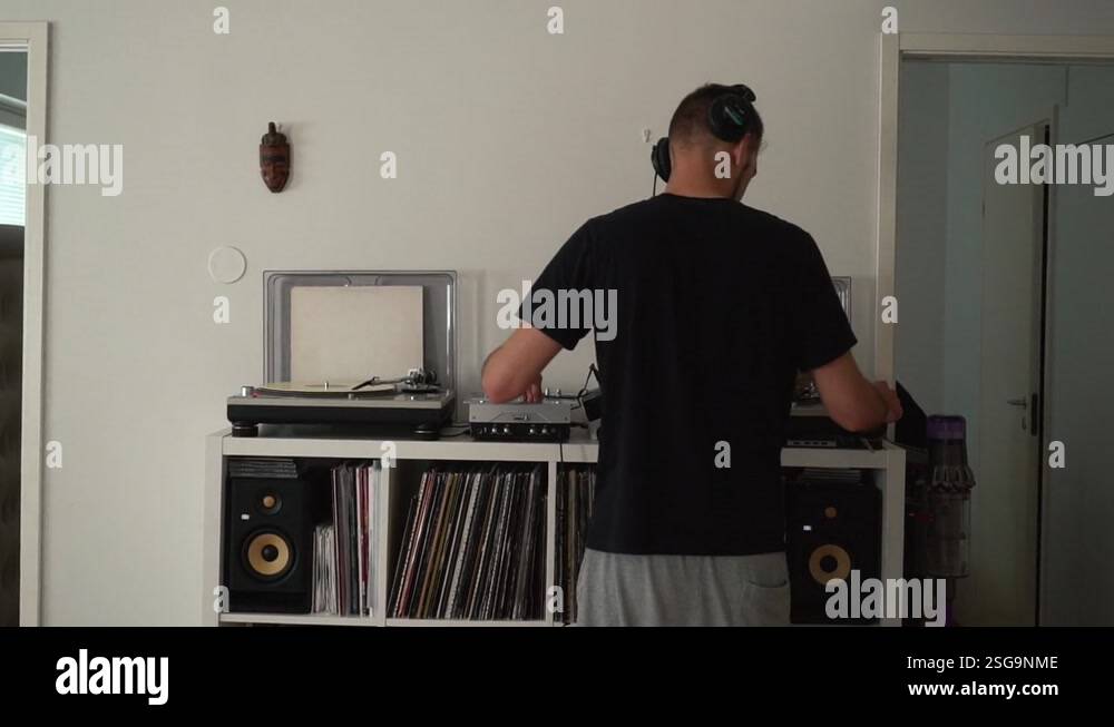 Vinyl playing. A man putting a vinyl music at home. DJ at home Stock ...
