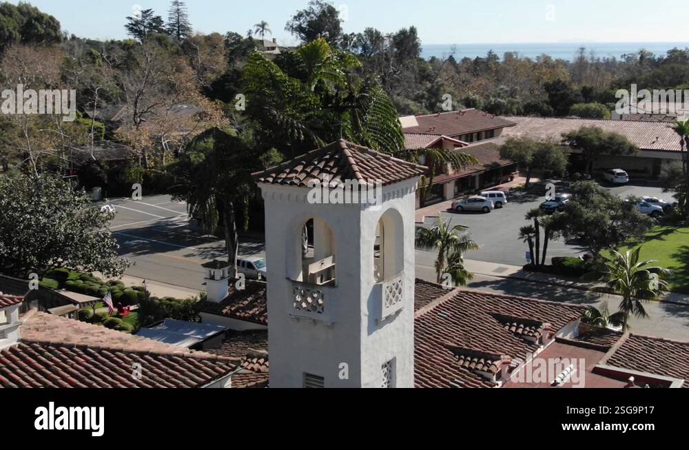 Aerial of old white bell tower in historic Montecito downtown in ...