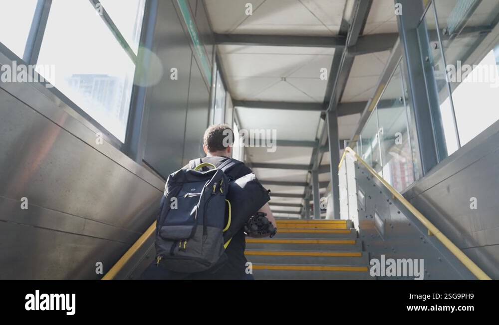 videographer carrying camera equipment up flight of stairs Stock Video ...