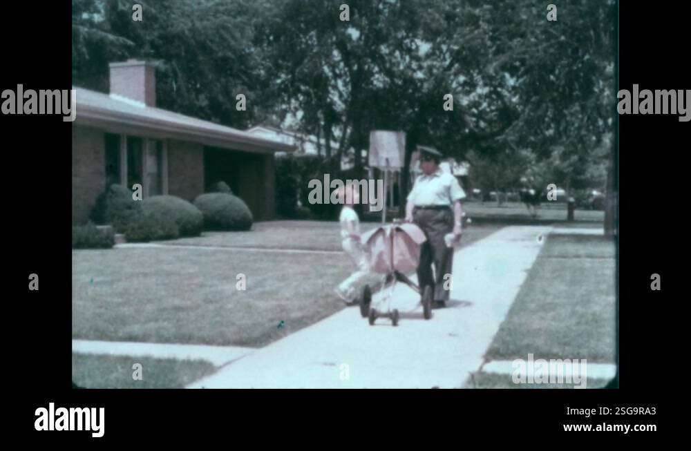 1960s: Mailman walks down sidewalk, pushes mail cart. Boy runs up to ...