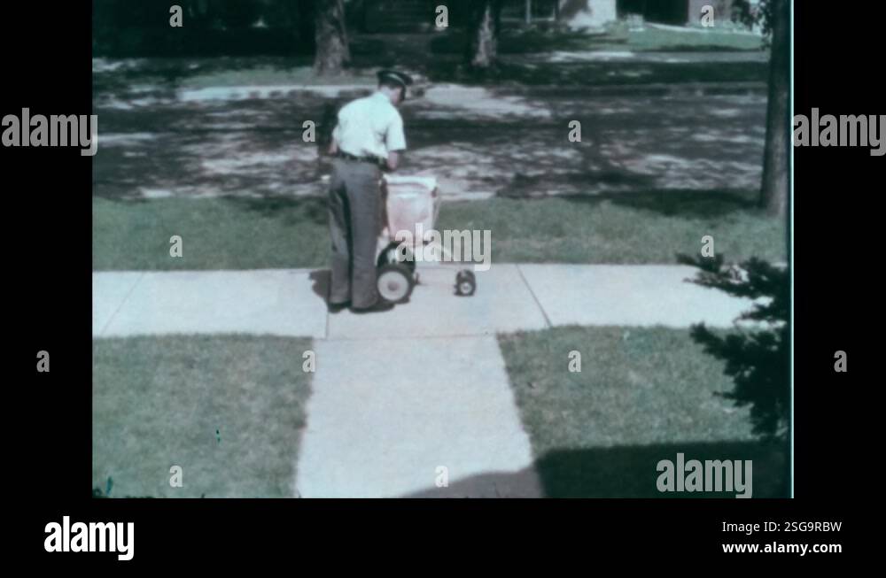 1960s: Mailman pushes cart down sidewalk, stops to deliver mail. Boy ...