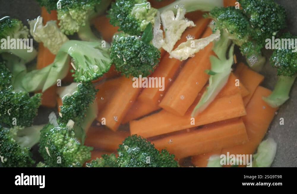 carrot and broccol was boiled in water in the pan. Healthy boil ...