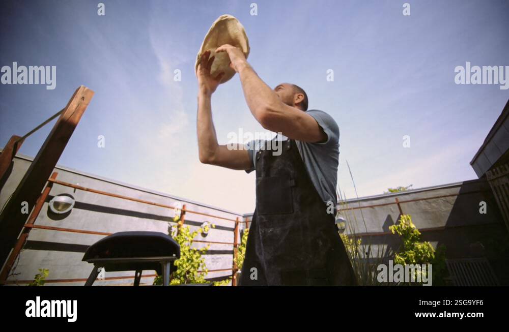 Man Tossing Pizza Dough Into Air And Catching It Stock Video Footage ...