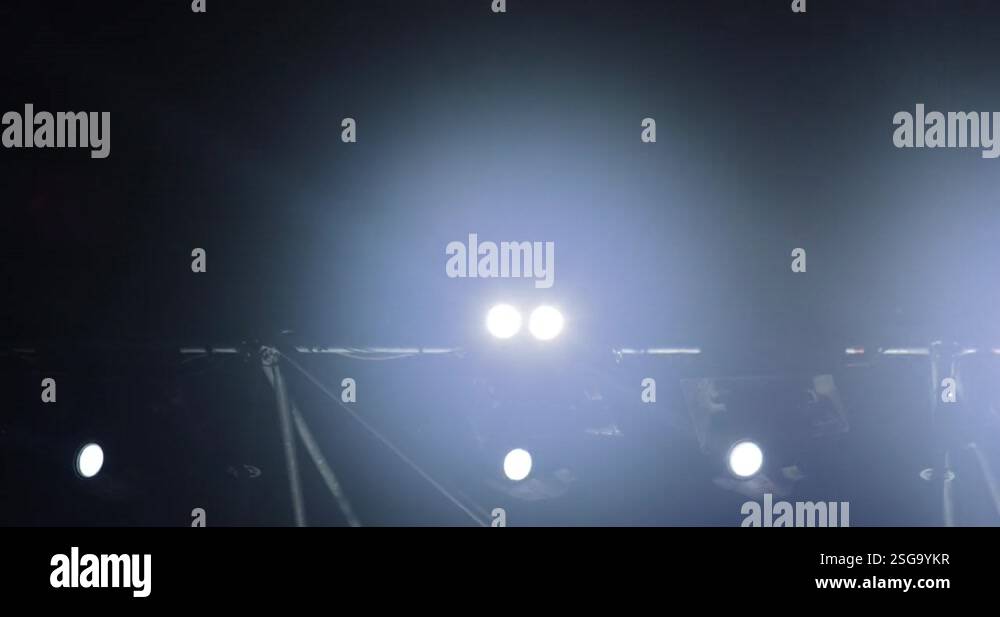 flashing and rotating light beams from stage lights on a construction ...