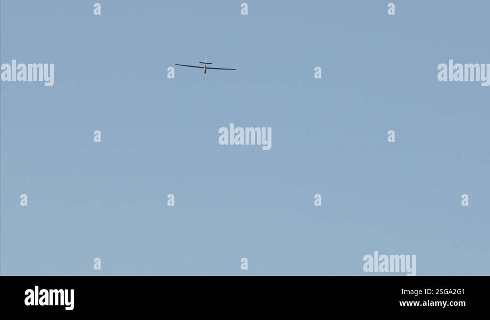 beautiful glider soars in blue sky and flies forward with currents of ...