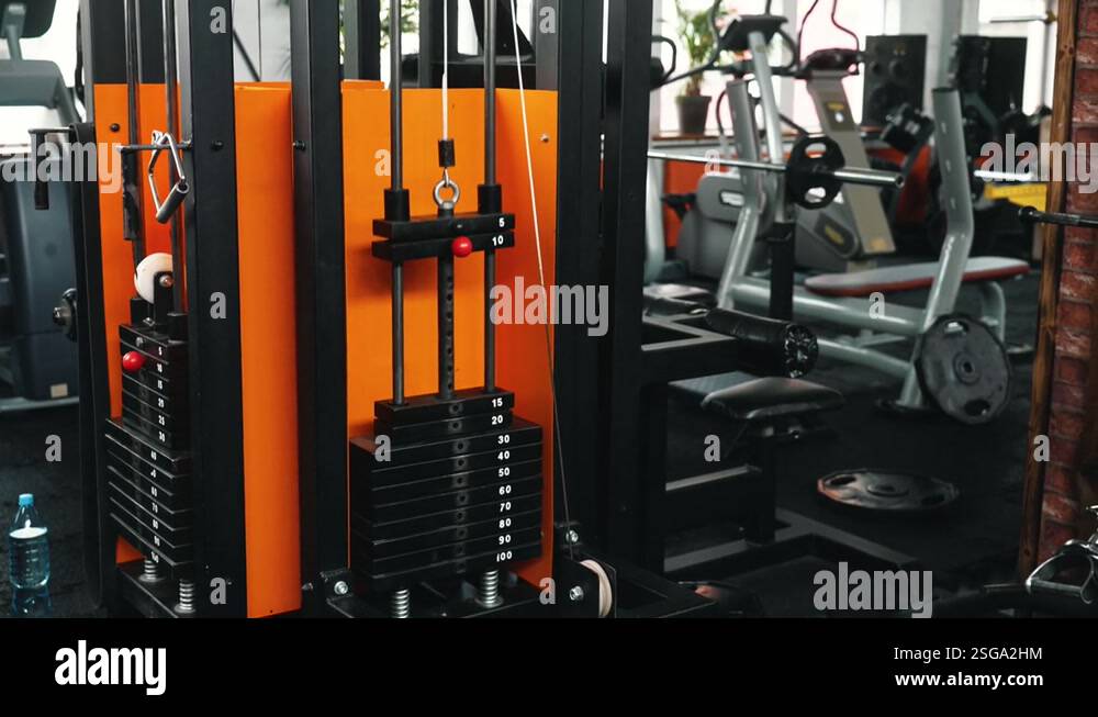 Weights moving up and down on lat pull down machine at well-equipped ...