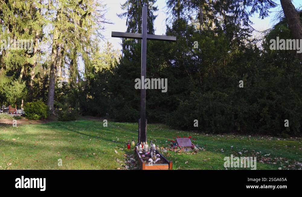 A close-up of the grave and the big Christian cross in the cemetery in ...