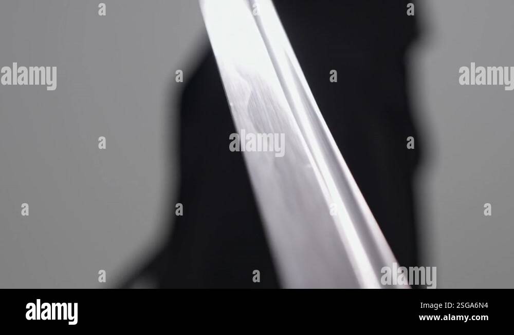 Japanese man, samurai, holds in his hand his sword, a katana in a ...