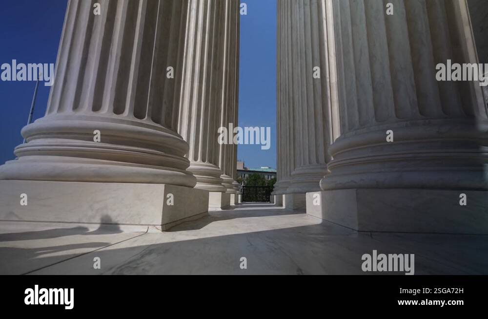 Wide angle pushing through very large towering columns in front of US ...