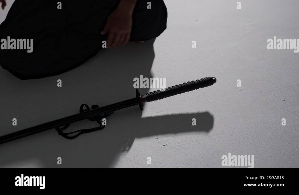 Japanese man, samurai, holds in his hand his sword, a katana in a ...