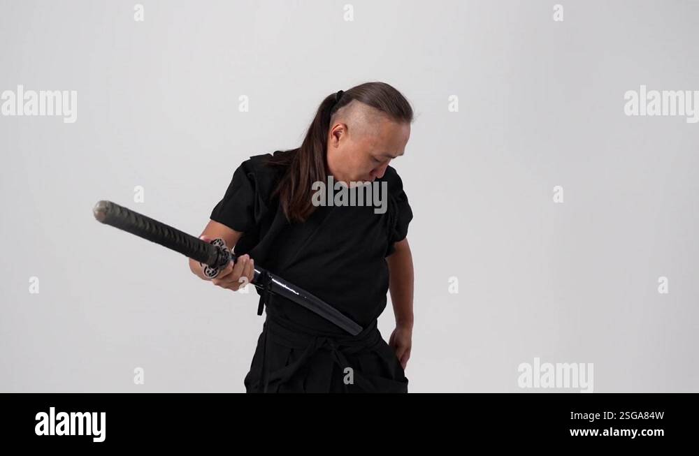 Japanese man, samurai, holds in his hand his sword, a katana in a ...