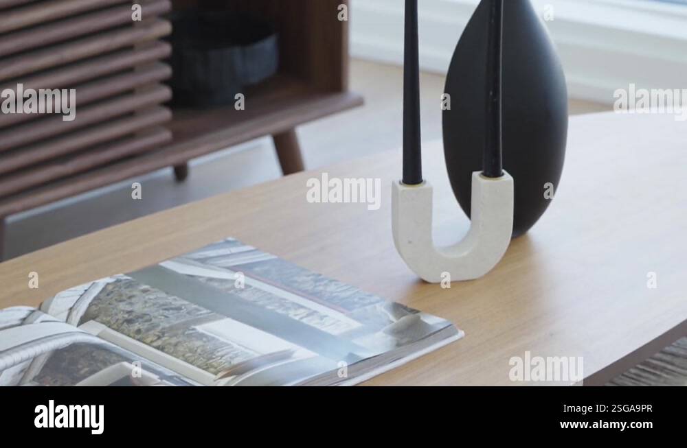 Detail tilt shot of the coffee table with book and candle on it in the Stock Video Footage - Alamy