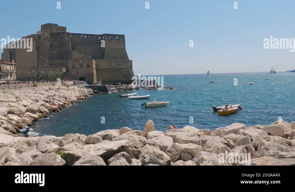 Panning Shot Revealing The Ovo Castle With Boats Anchored In The Ocean ...