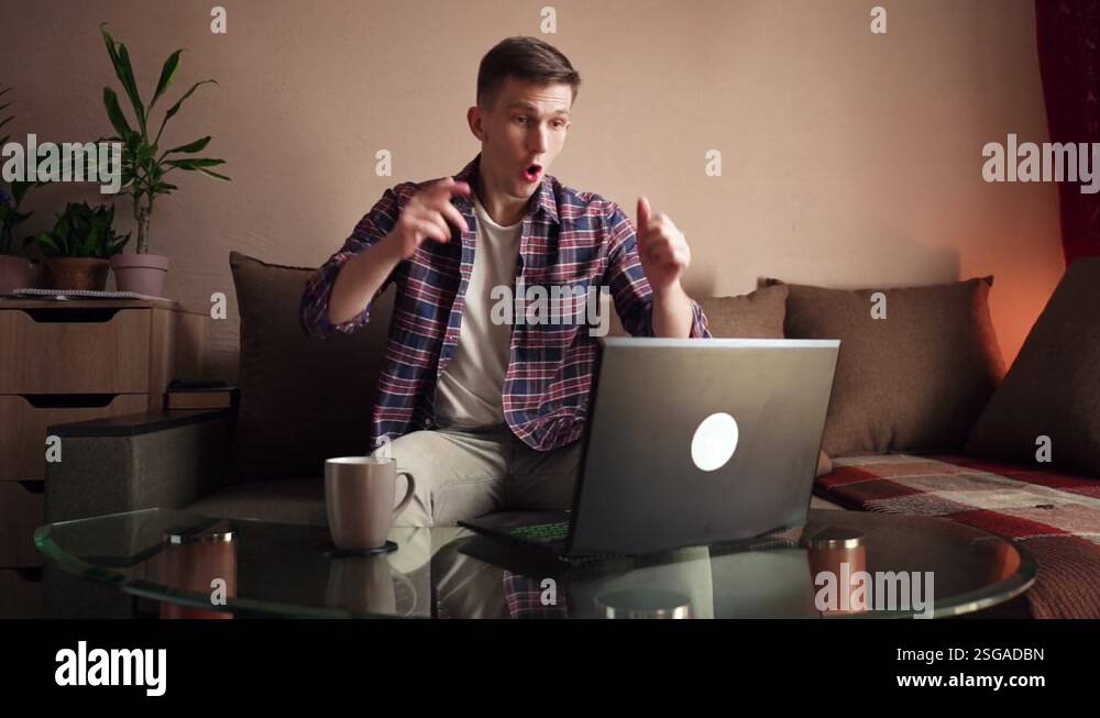young happy man received good news in the mail. happy reaction. laptop ...