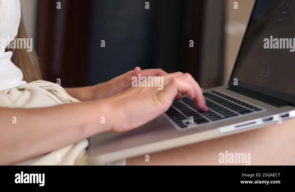 Closeup of a girl working and writing emails on laptop computer ...