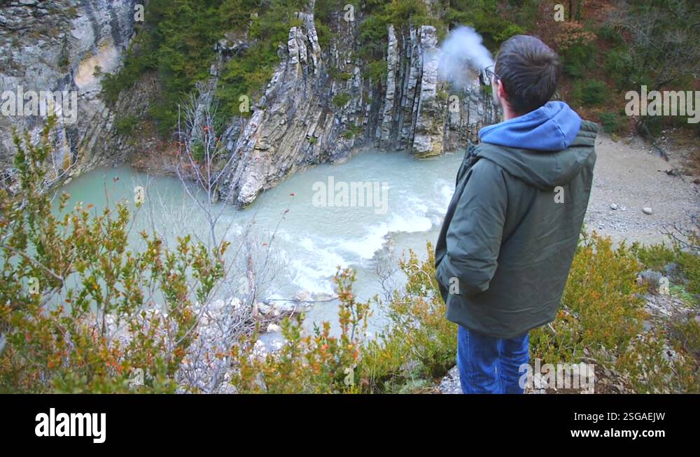 Man smoking a sigaret and looking at the river Méouge in France Stock ...