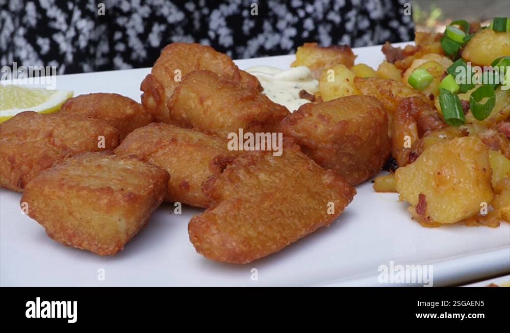 Adding salt and lemon to deep fried fish pieces Stock Video Footage - Alamy