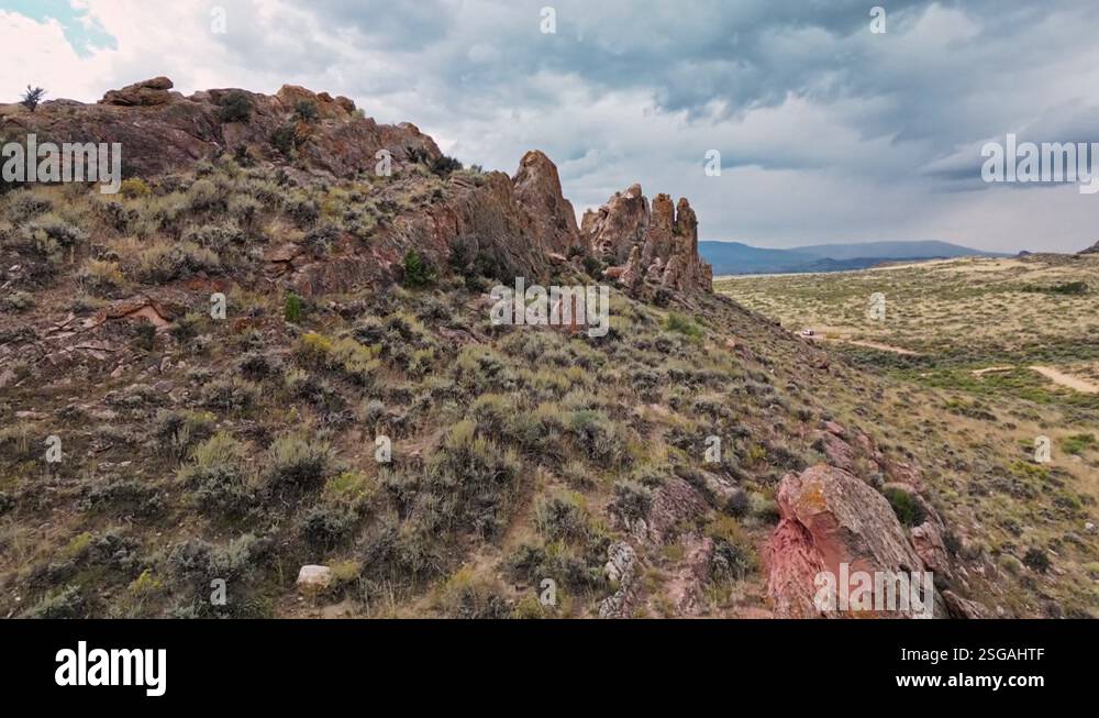 Flying up and through rocky cliff formation along the shore of Flaming ...