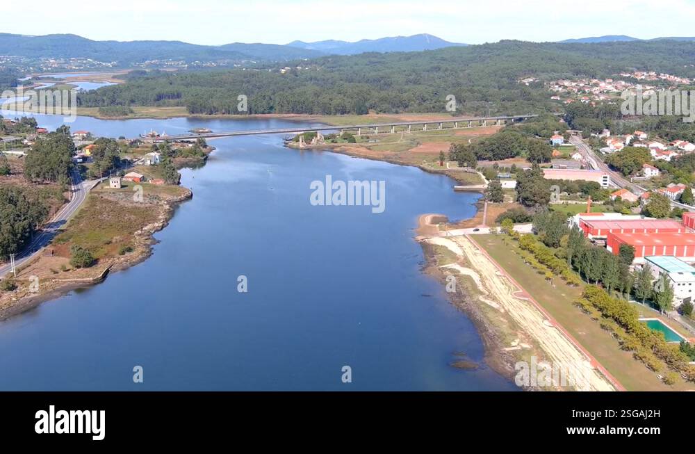 Bridge over the Ulla River with small industrial areas on the sides and ...
