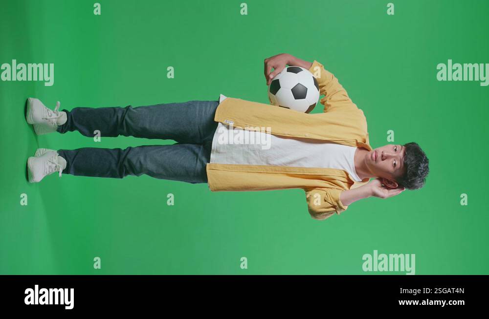 Full Body Of Asian Boy With A Ball Cupping Ear To Listen While Cheering ...