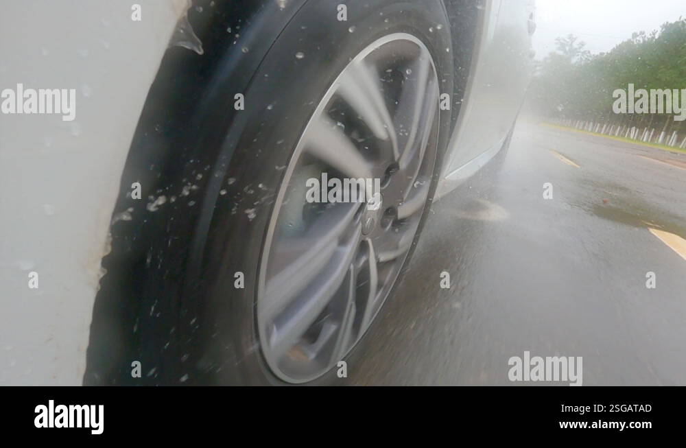 Close-up Shot Of A White Peugeot 208's Wheel Spinning Quickly Splashing ...