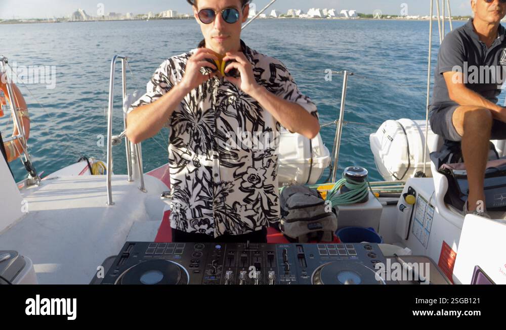 DJ playing music on a Catamaran sail boat for a wedding party Stock ...