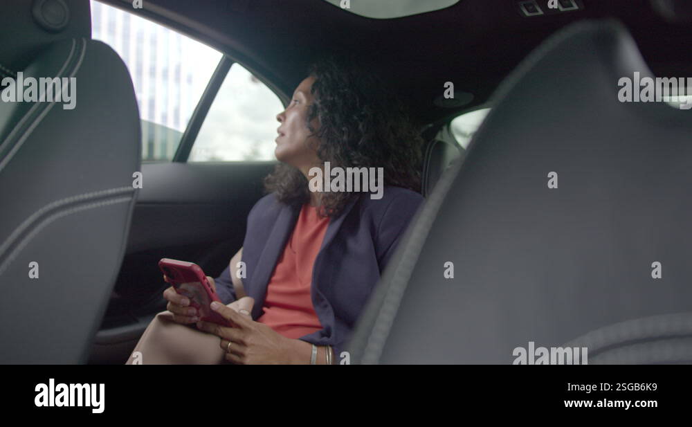 Businesswoman in Taxi using Smart phone Technology on Commute and ...