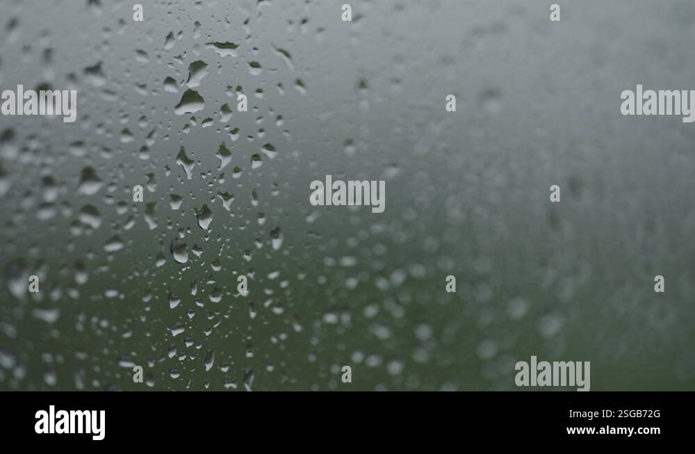 Real background of rain hitting glass window Stock Video Footage - Alamy