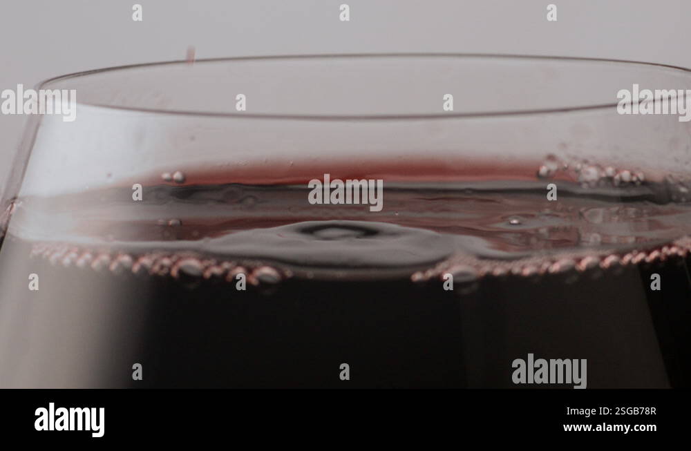 Closeup red wine droplet falling on smooth surface alcohol drink ...