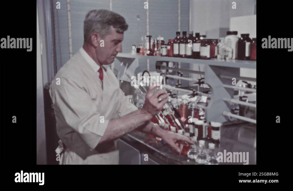 1960s: Man mixes chemicals in laboratory. Orange labeled Color Added ...