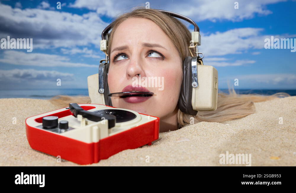 Woman buried in sand on beach with record player Stock Video Footage ...