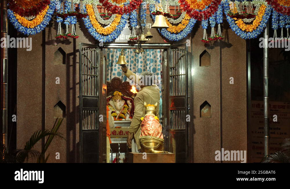 Mini Hindu temple with ganesha and worshipper at night Stock Video ...