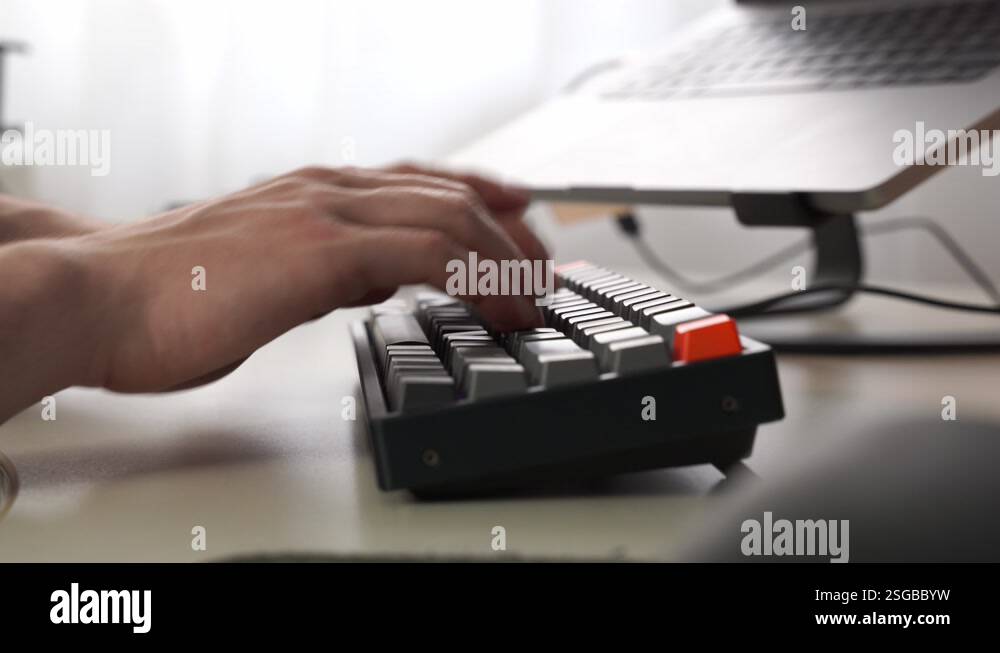 male hands start to type at a fictitiously high rate of speed on a ...