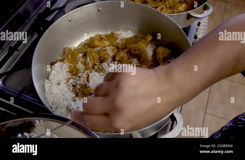 Chef Adding White Rice To Layer Chicken Curry In Large Pot. Slow Motion ...