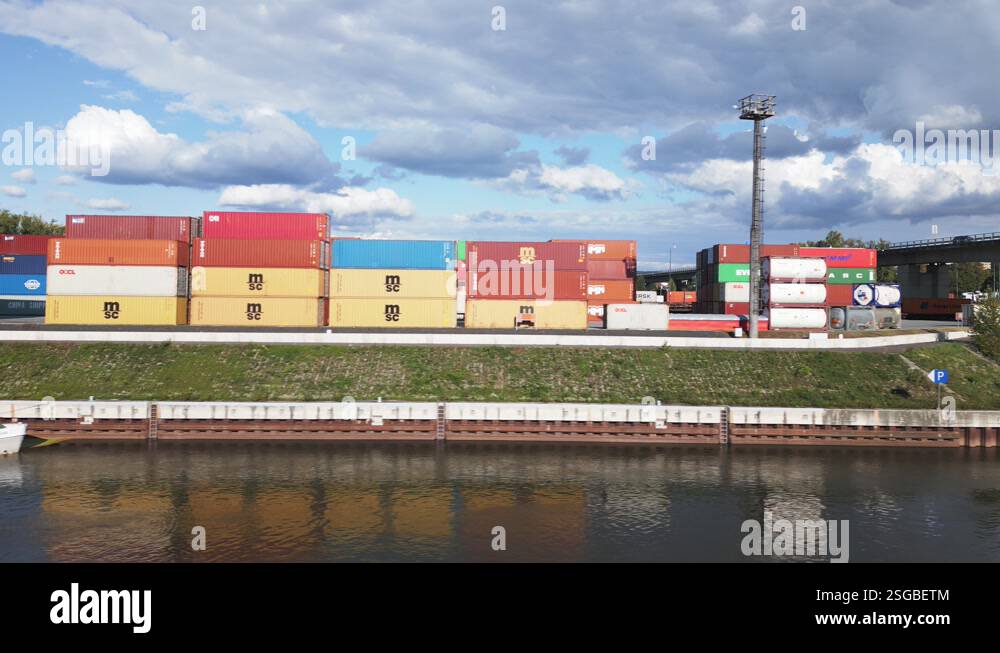 Shot from the river of rows of containers in the international cargo ...