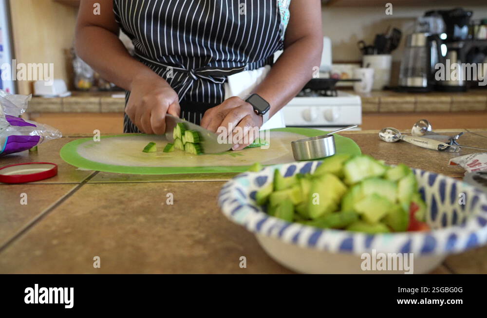 Dicing cucumber to add to the avocado and tomatoes in making a chopped ...