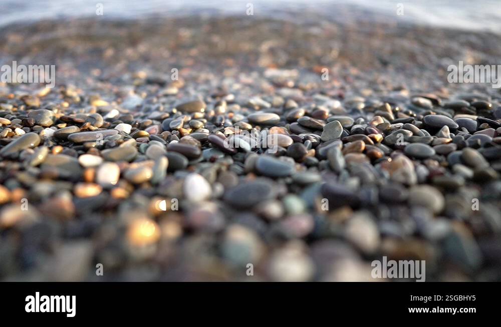 Close-up Pebbly Beach and Water Surface of a Clear Calm Sea. Super Slow ...