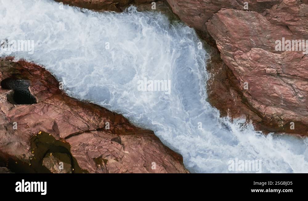 Mountain river. A rapid flow of clean water trapped between rocks ...