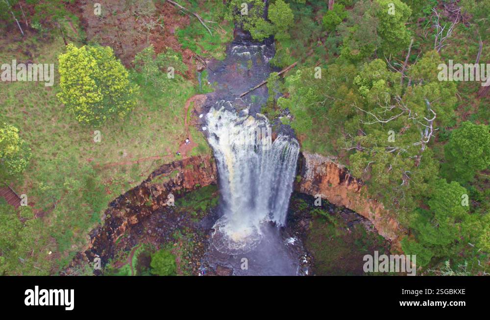 Rising aerial footage of water flowing over the Trentham Falls after ...