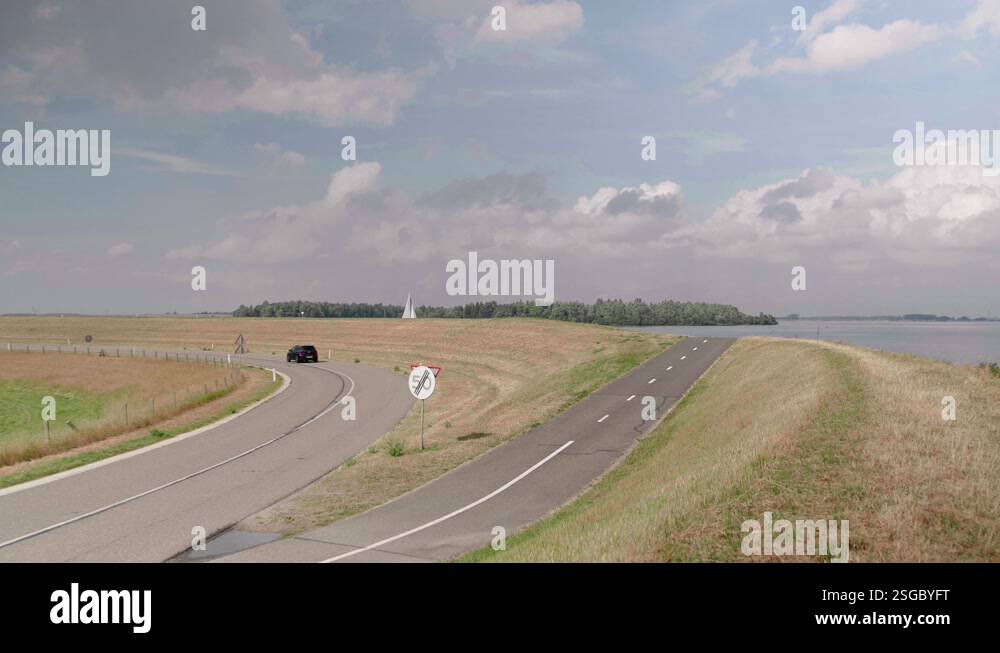 car driving by in a curve on a dutch polder dike road Stock Video ...
