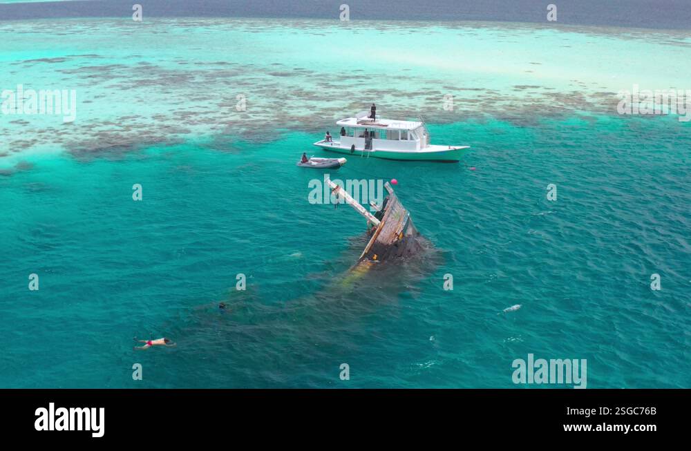 Aerial view on Shipwreck and Boats with tourists in Vaavu Atoll near ...