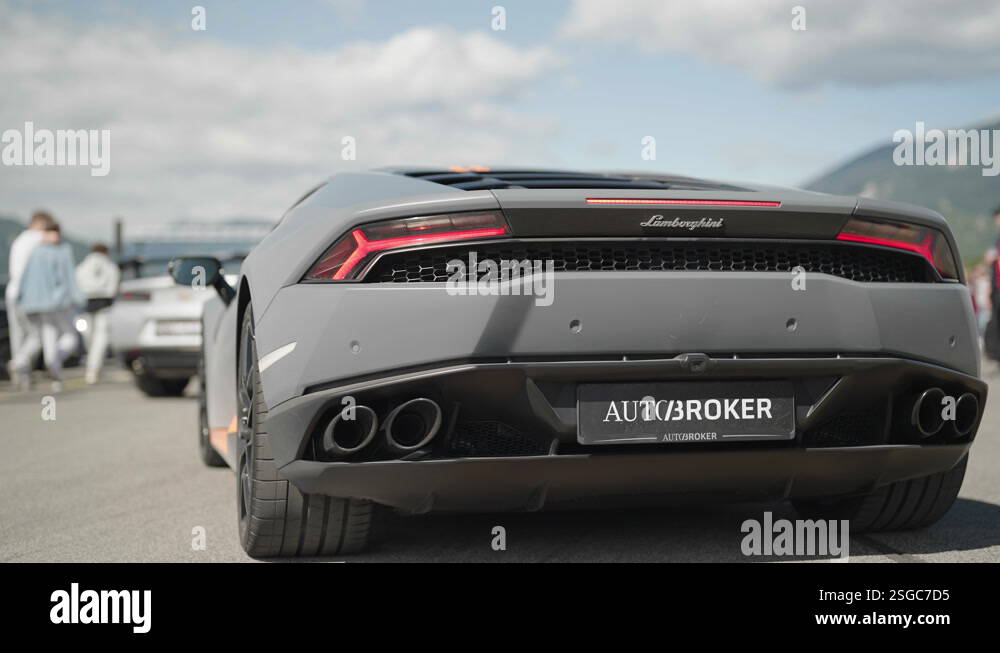 Tracking Lamborghini supercar from rear driving on exhibition event 4K ...