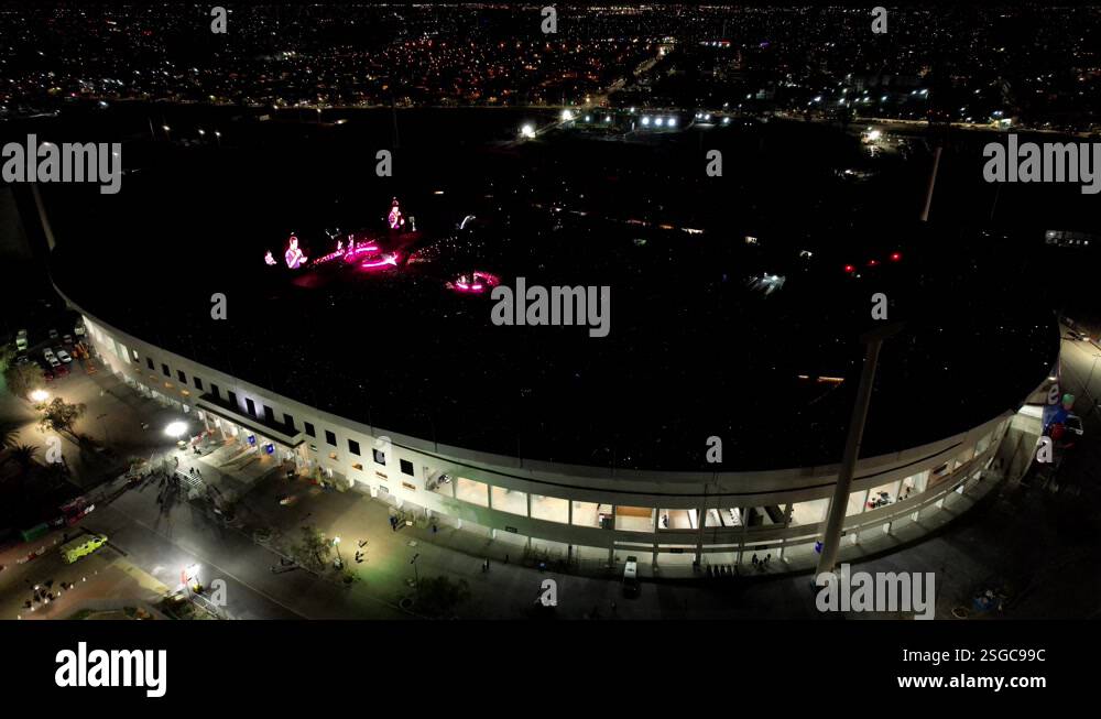 Aerial view of a big concert at night in an open-air stadium in the ...