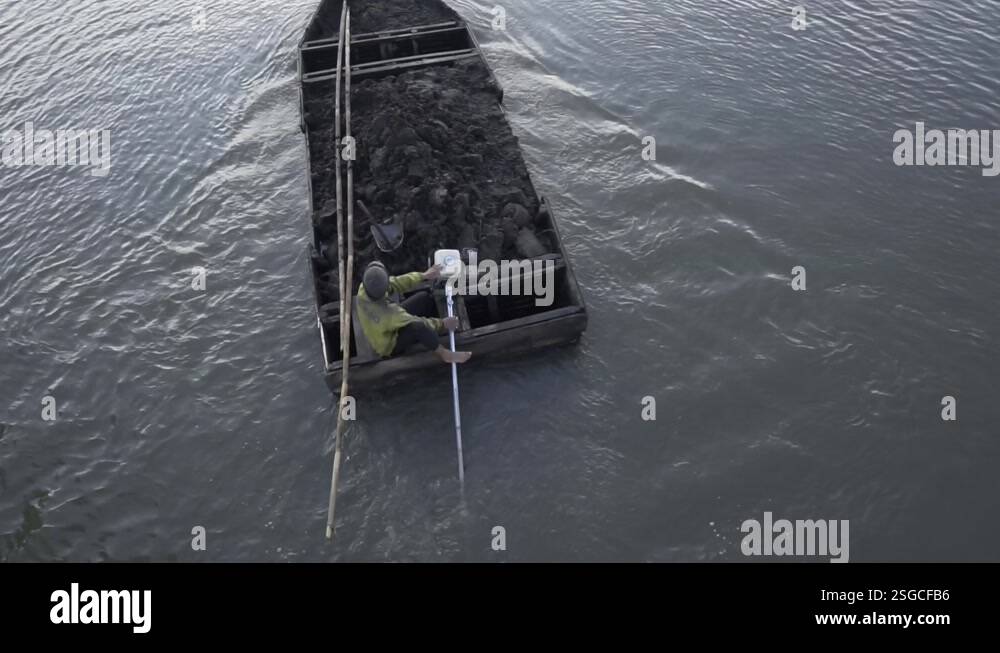 Semarang, Indonesia: Residents transport peat soil on a boat on Rawa ...
